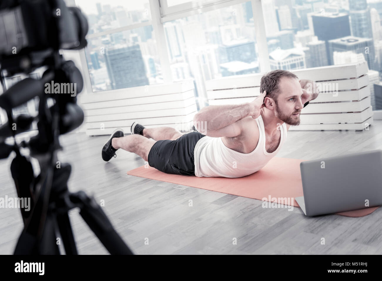 Confident male blogger performing exercise Stock Photo - Alamy