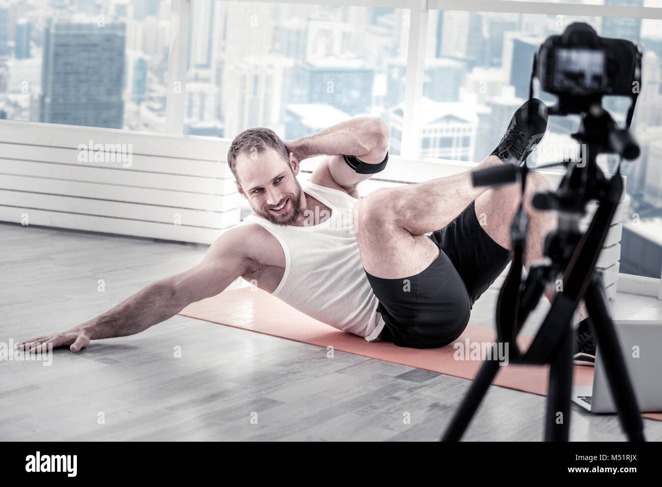 Happy male blogger training abs Stock Photo - Alamy