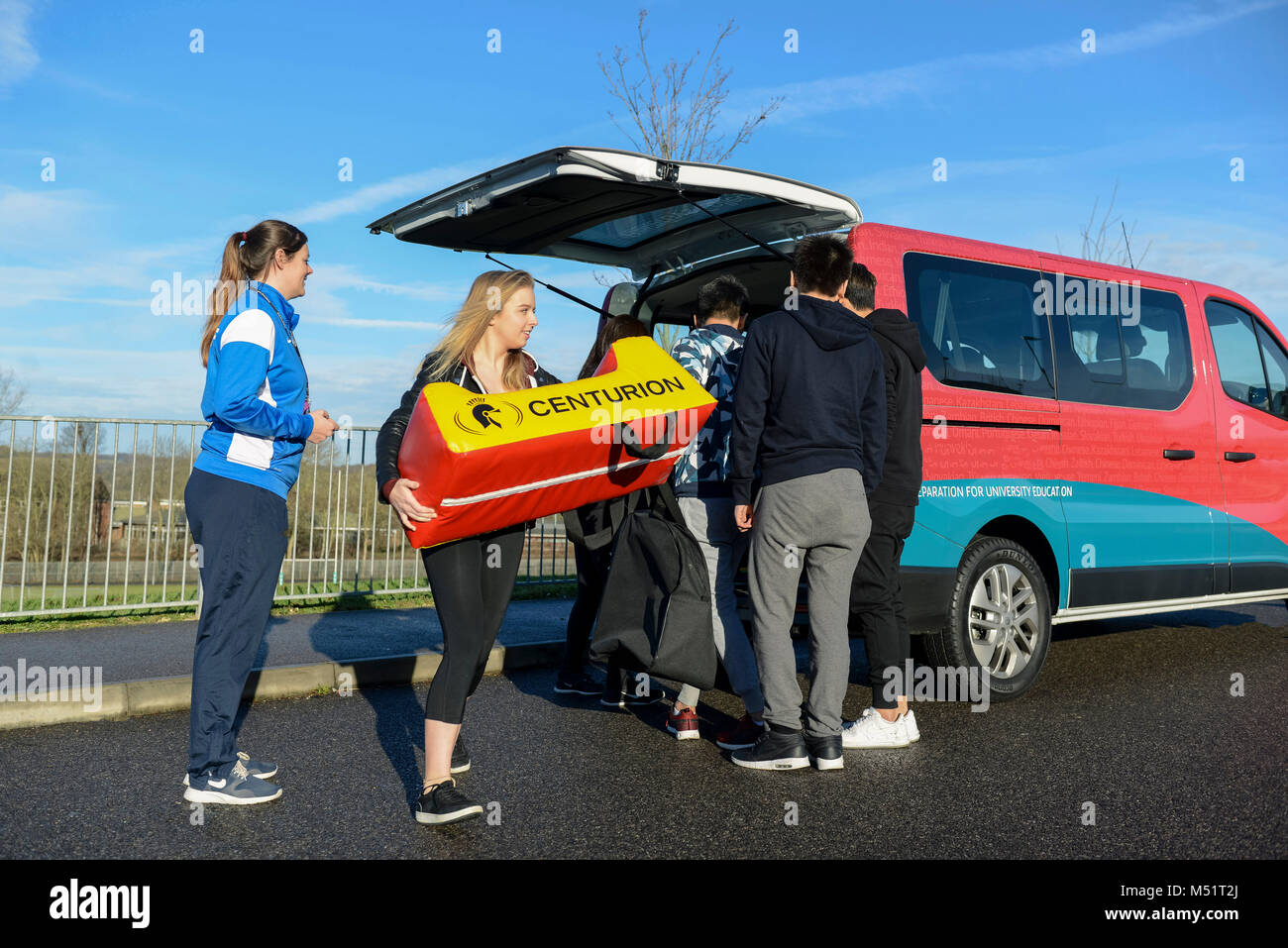 school college kids taking physical education / p.e. sports equipment ...