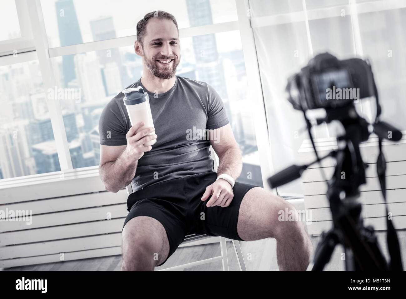 Merry male blogger relaxing after workout Stock Photo - Alamy