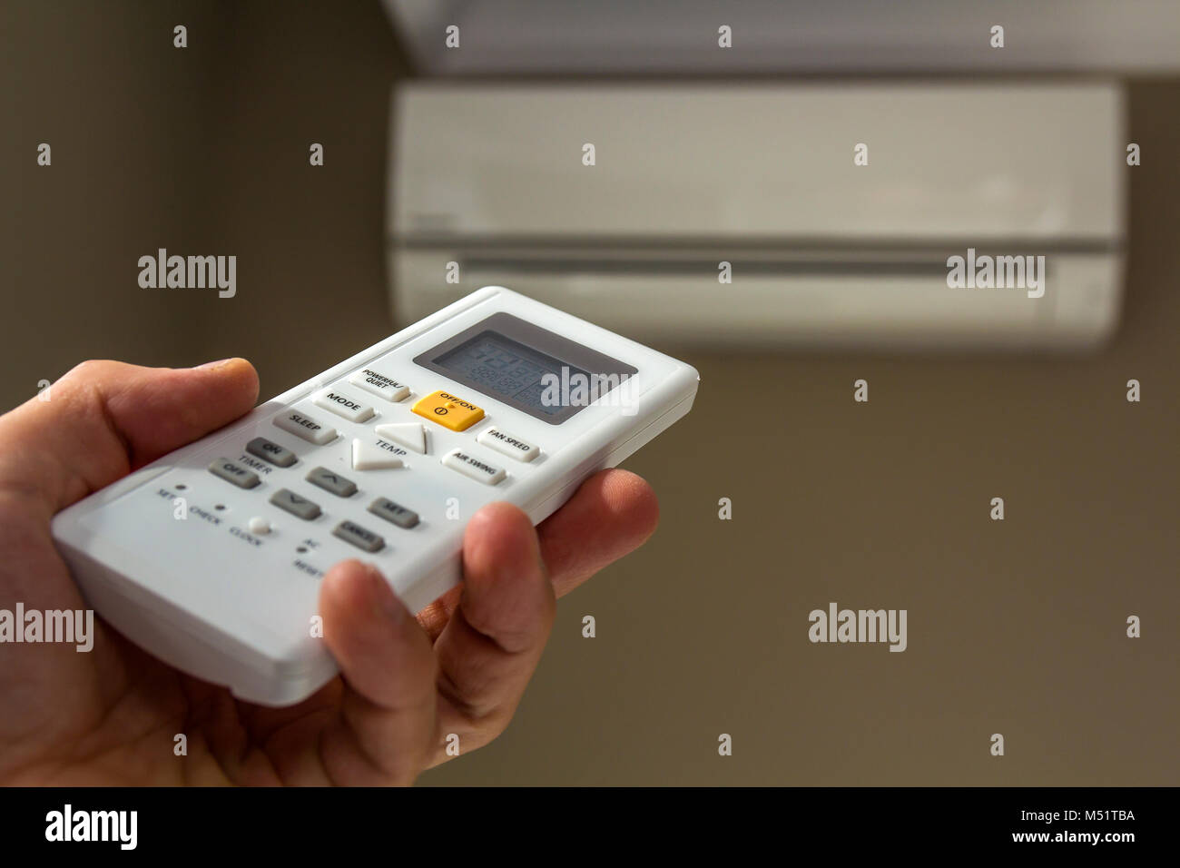 Hand holdind control switch of home air conditioner Stock Photo - Alamy
