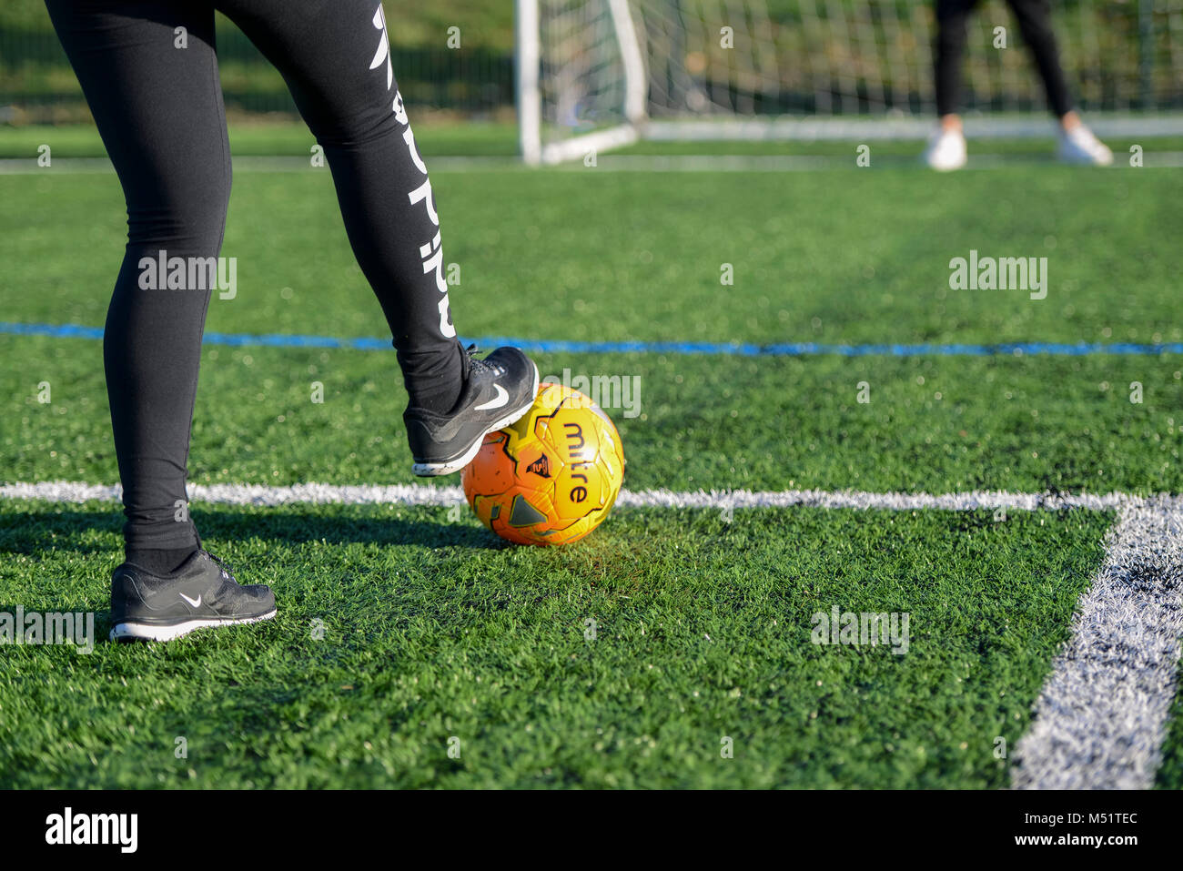 school students having a football lesson to improve their skills at ...