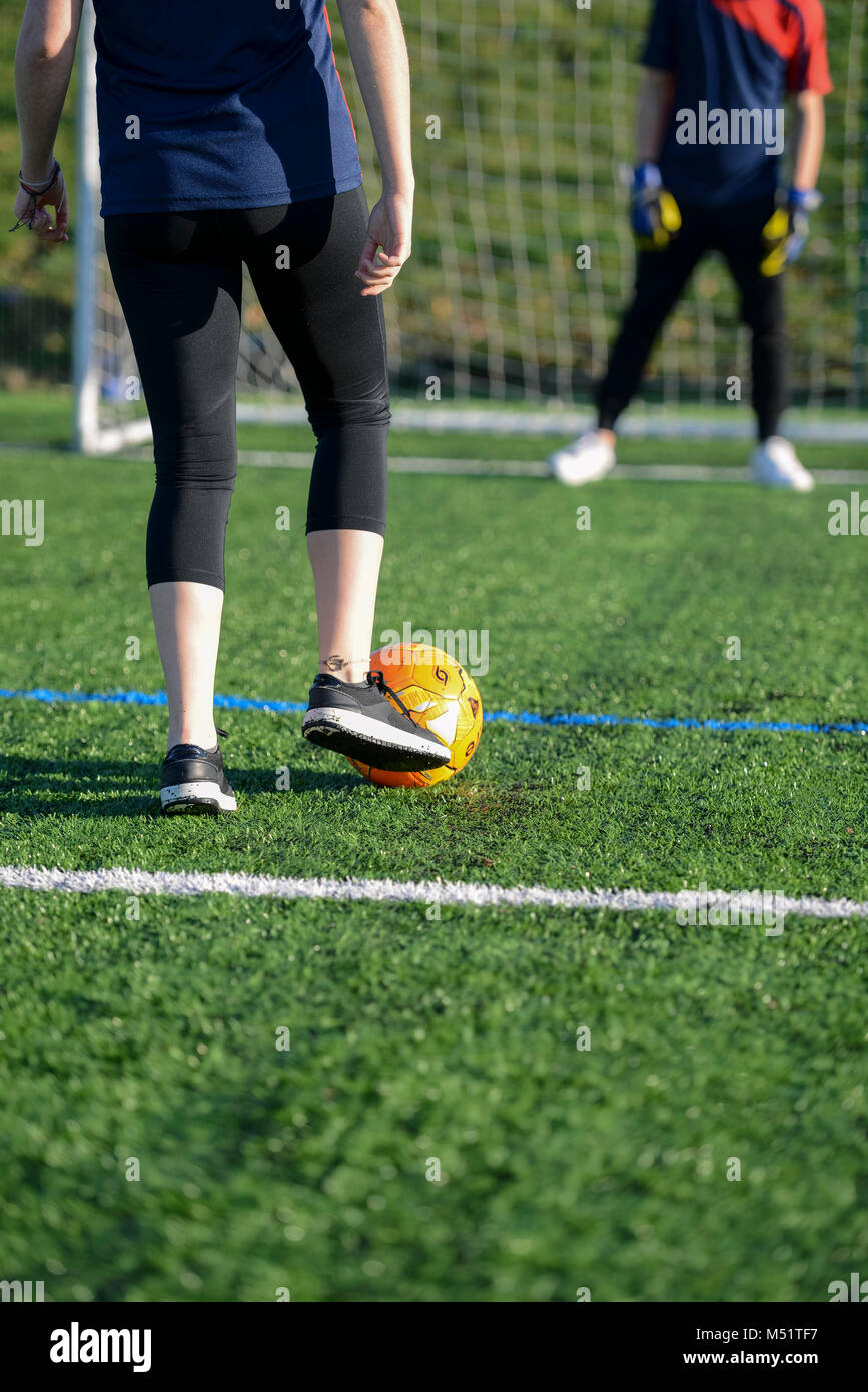 school students having a football lesson to improve their skills at ...