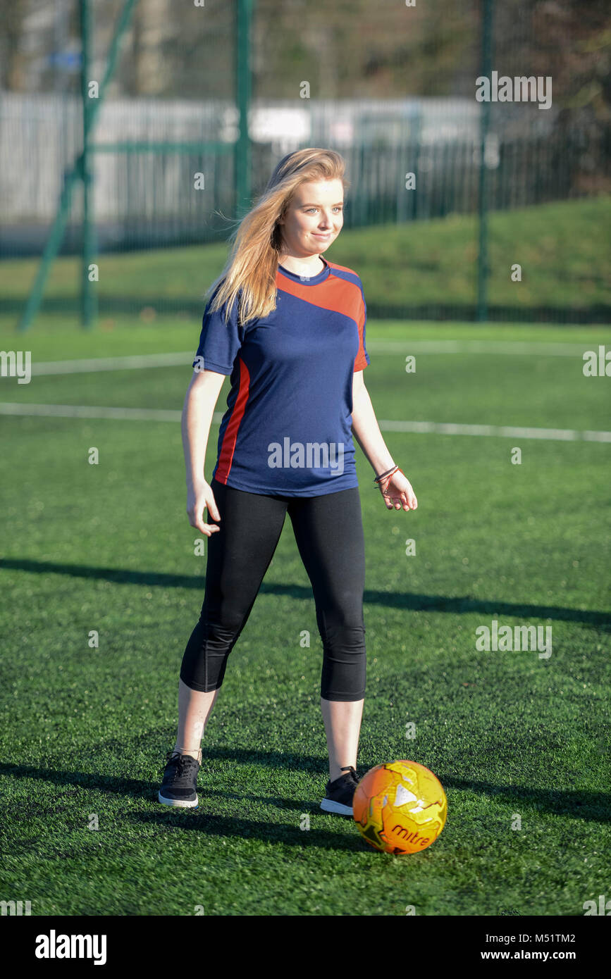 school students having a football lesson to improve their skills at ...