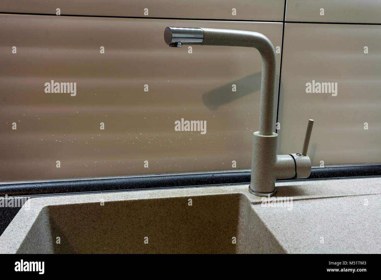 Close up new yellow metal faucet in a kitchen Stock Photo - Alamy