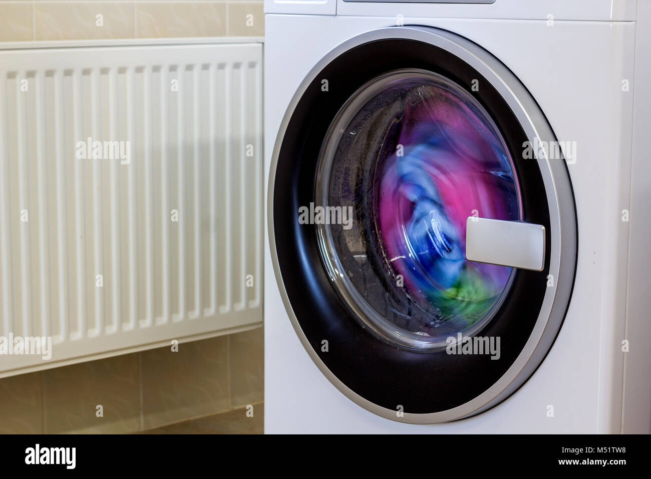 Colorful clothes and towels in washing machine Stock Photo - Alamy
