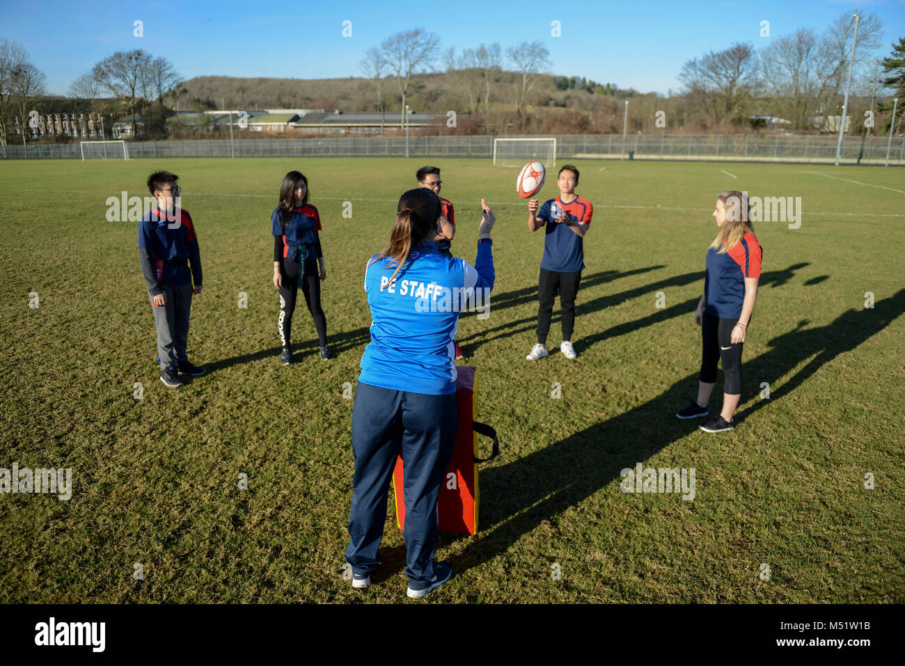 A school PE lesson where the teacher is teaching the college students ...