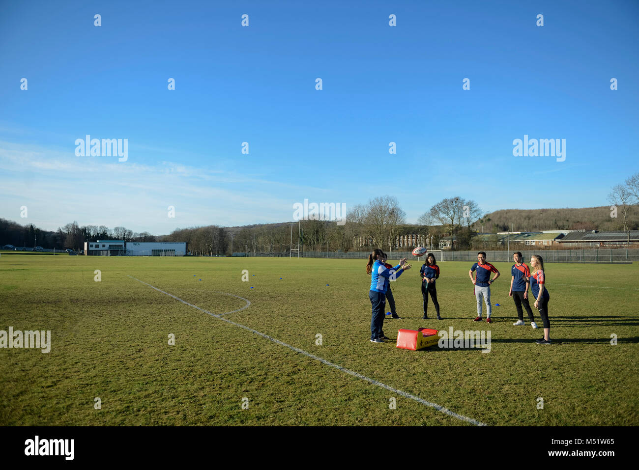 A school PE lesson where the teacher is teaching the college students ...