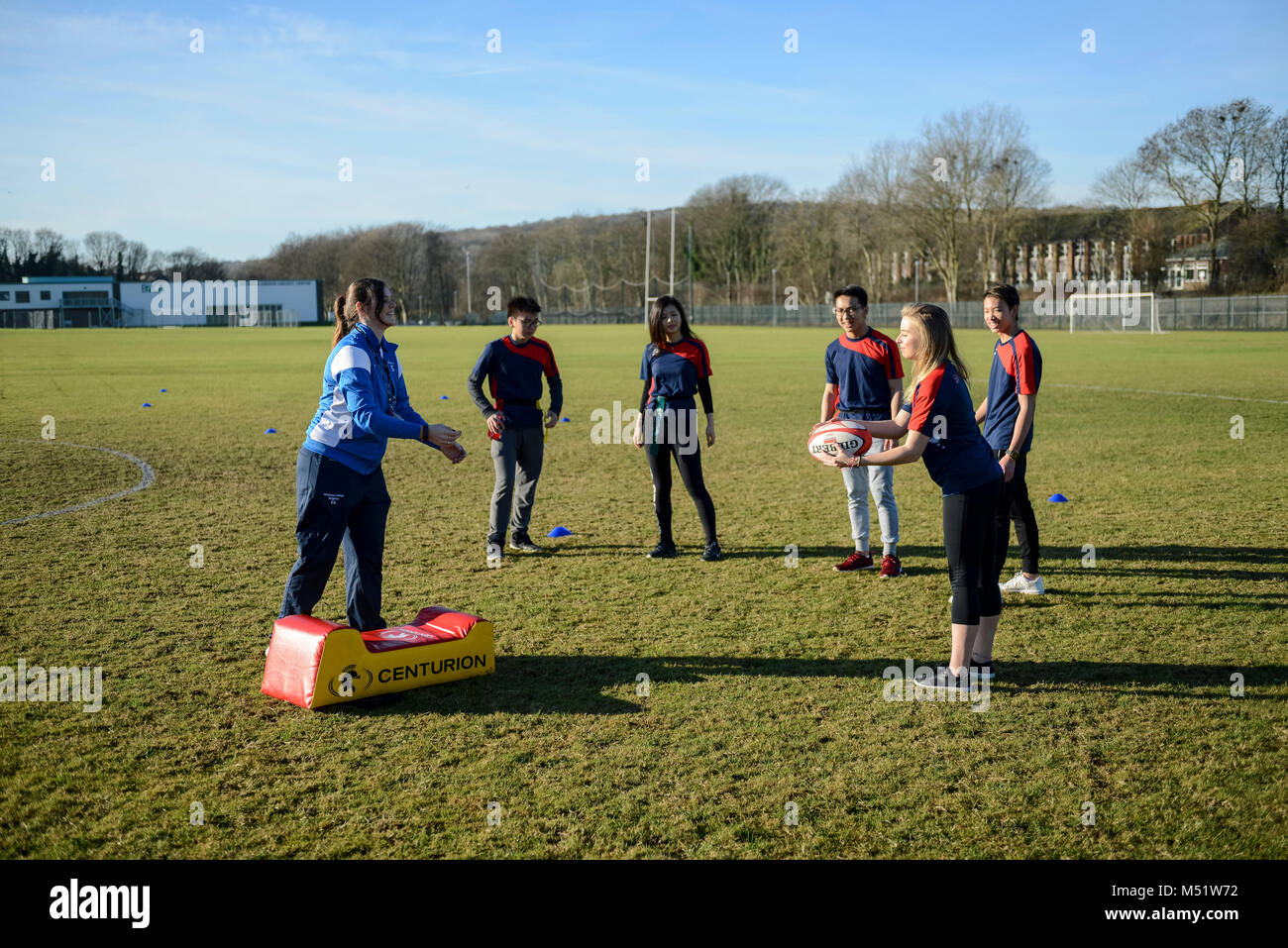 A school PE lesson where the teacher is teaching the college students ...