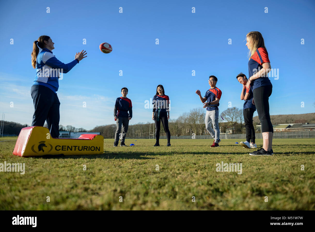 A school PE lesson where the teacher is teaching the college students ...