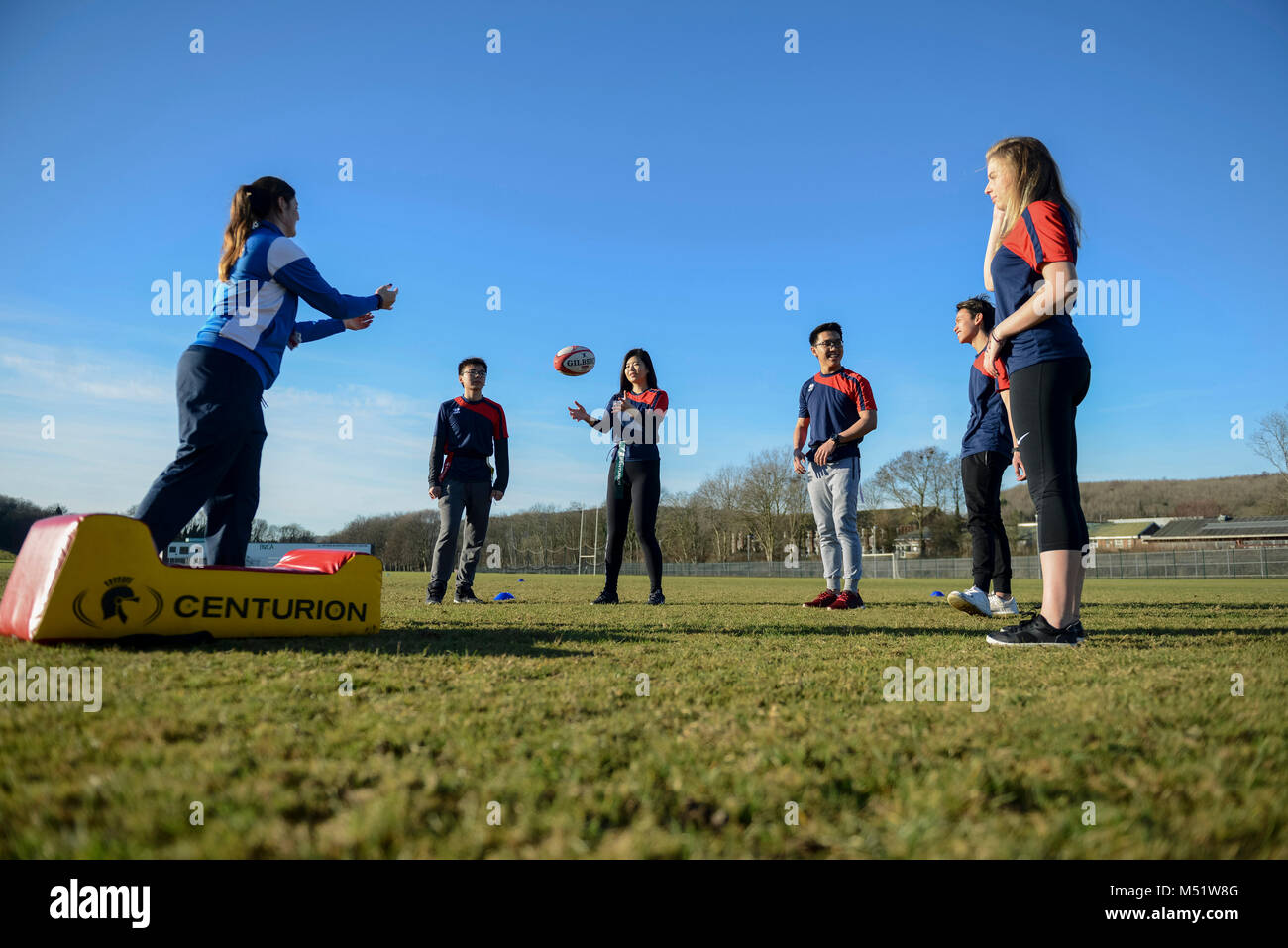A school PE lesson where the teacher is teaching the college students ...