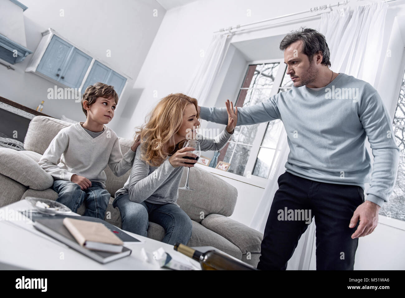 Alcoholic woman feeling scared while her aggressive husband grabbing ...