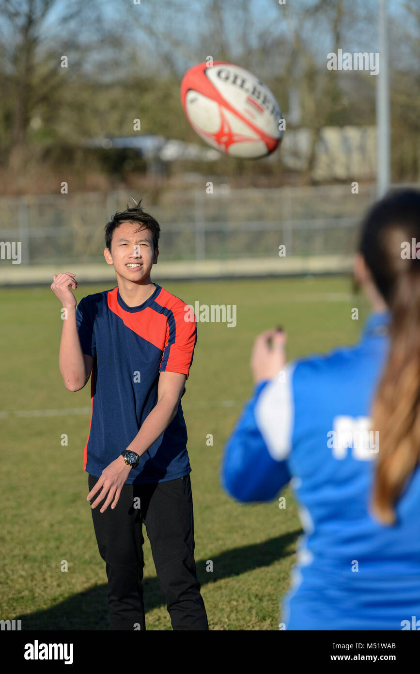 A school PE lesson where the teacher is teaching the college students ...