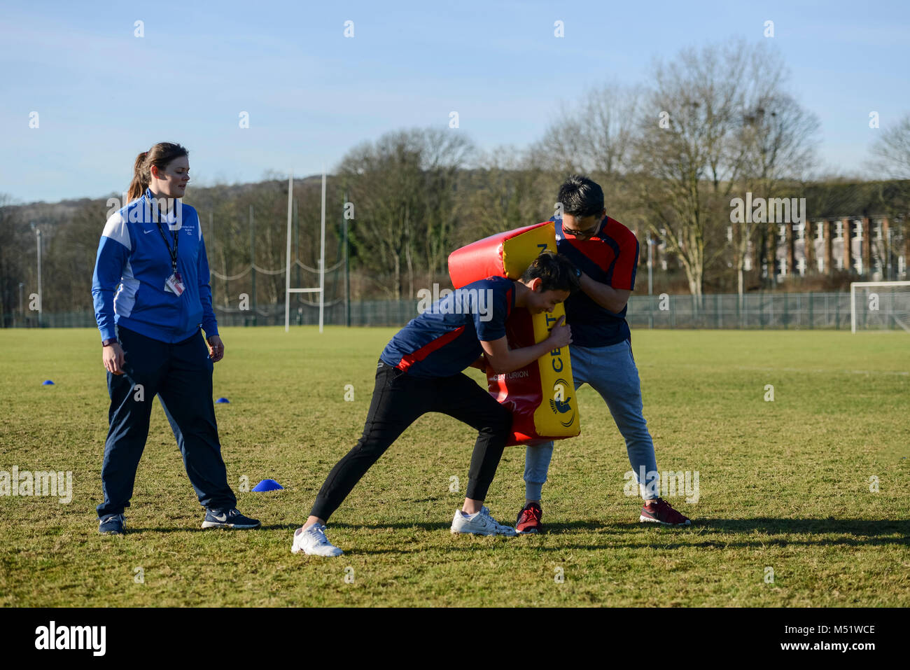 A school PE lesson where the teacher is teaching the college students ...