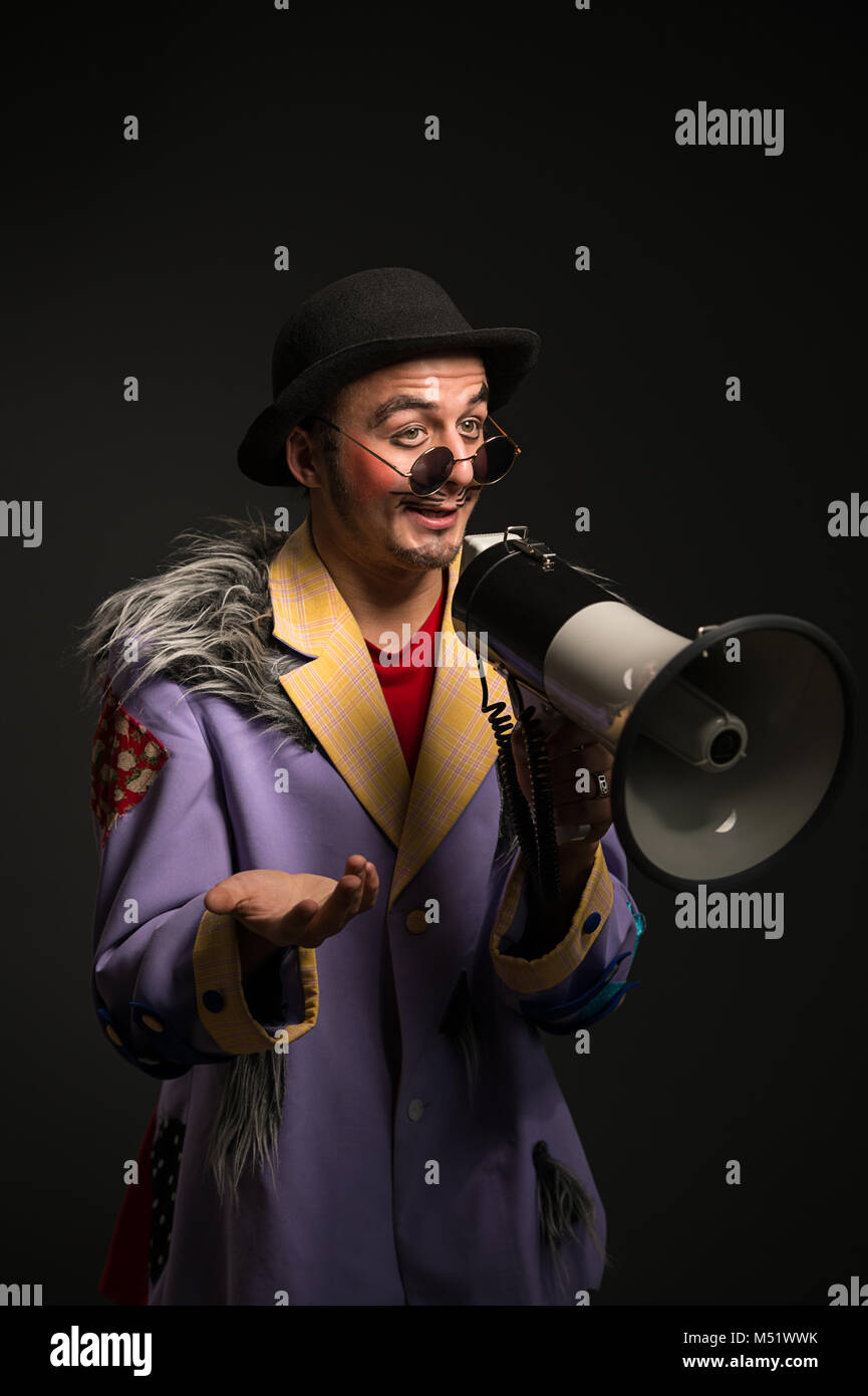 Clown shouting at the megaphone Stock Photo - Alamy