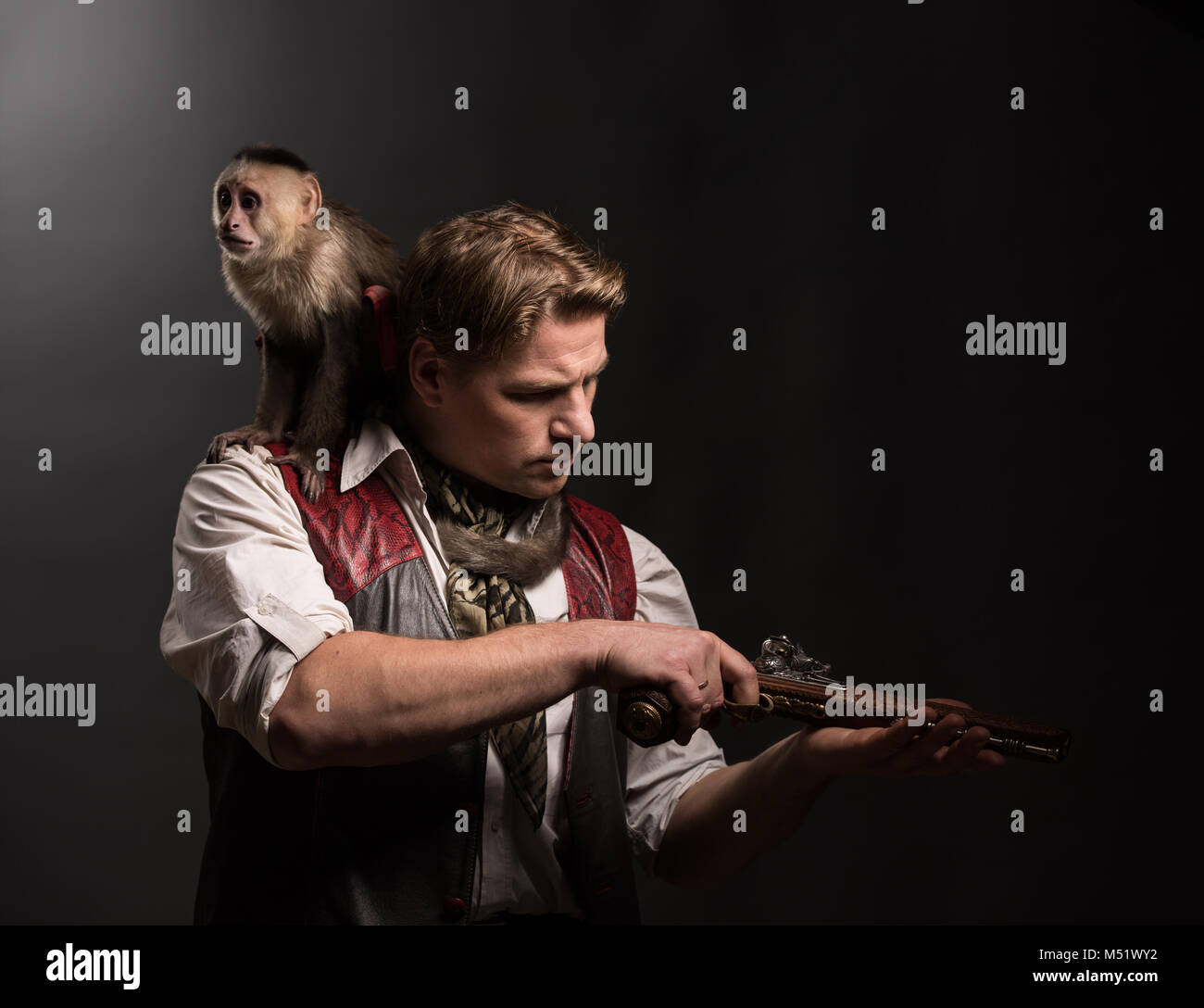 Mature man adventurer in costume of traveler with his monkey companion ...