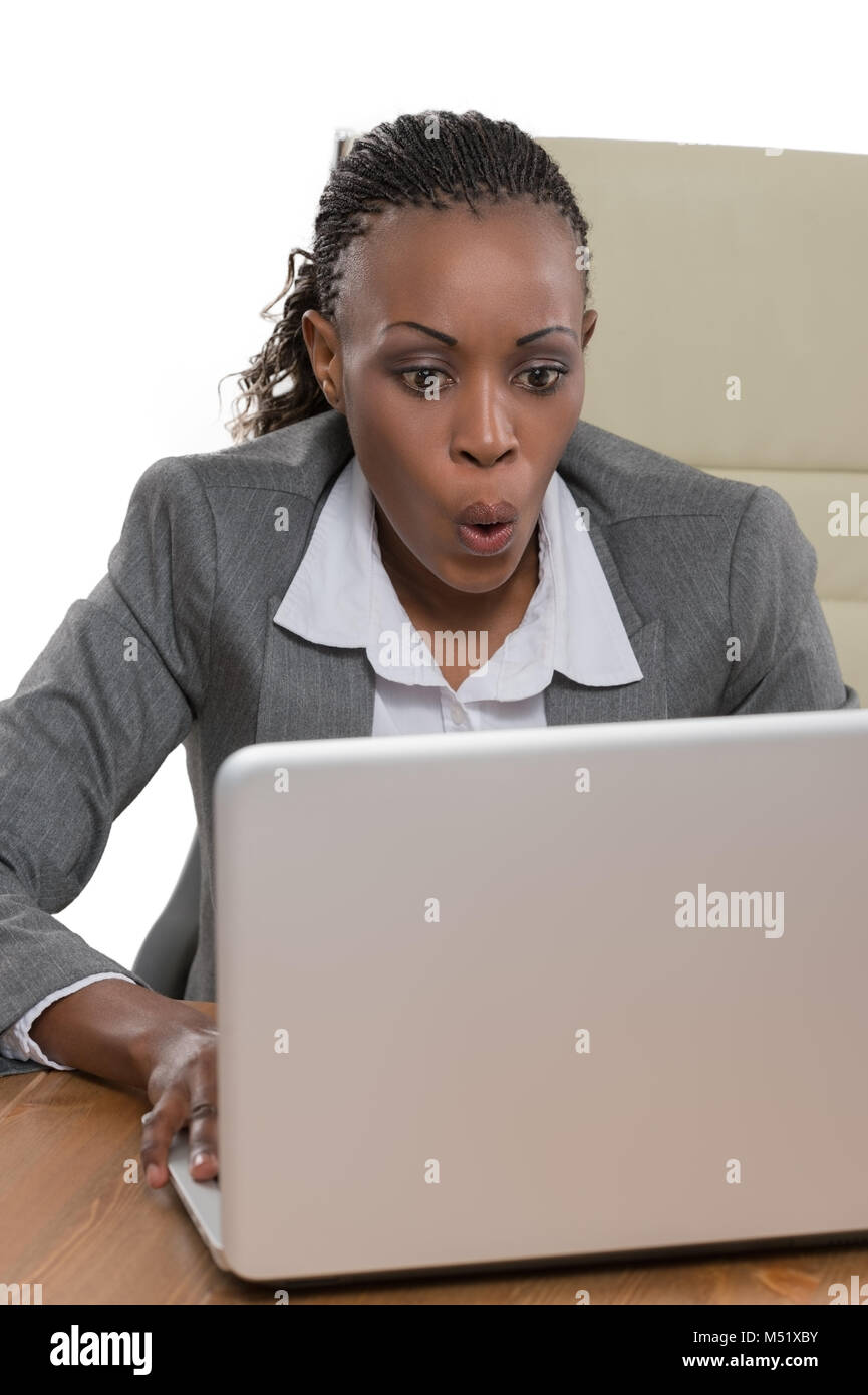 African business woman sitting at her desk and working with laptop ...