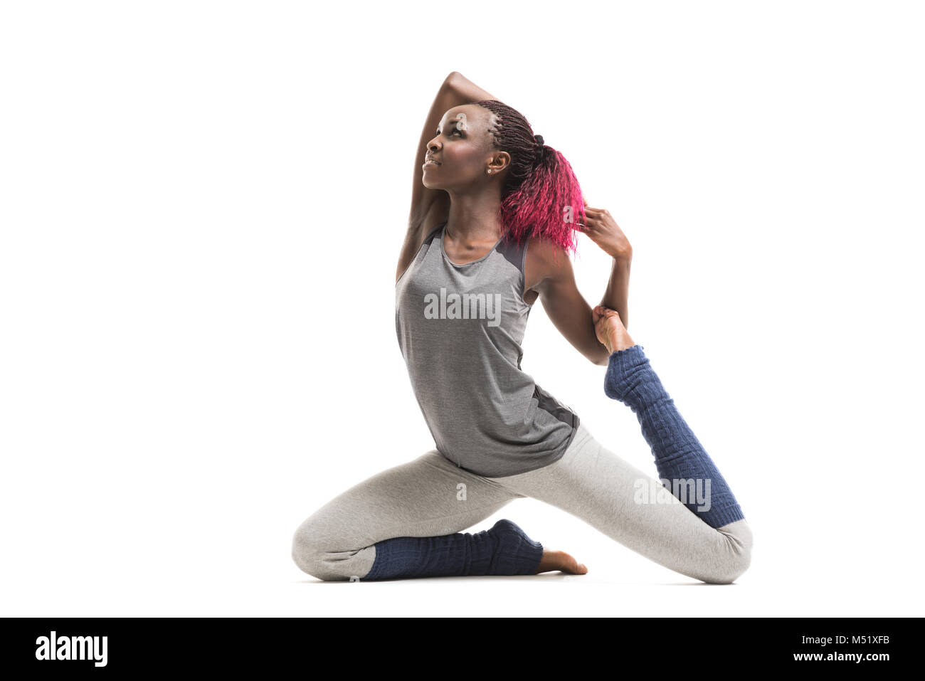 Young african woman doing yoga exercises isolated on white background ...
