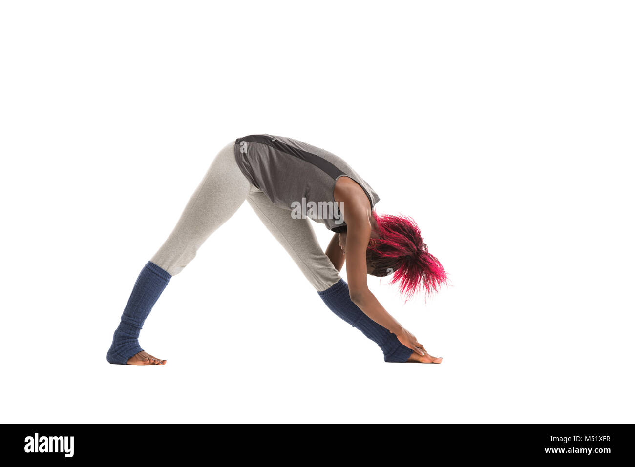Young african woman doing yoga exercises isolated on white background ...