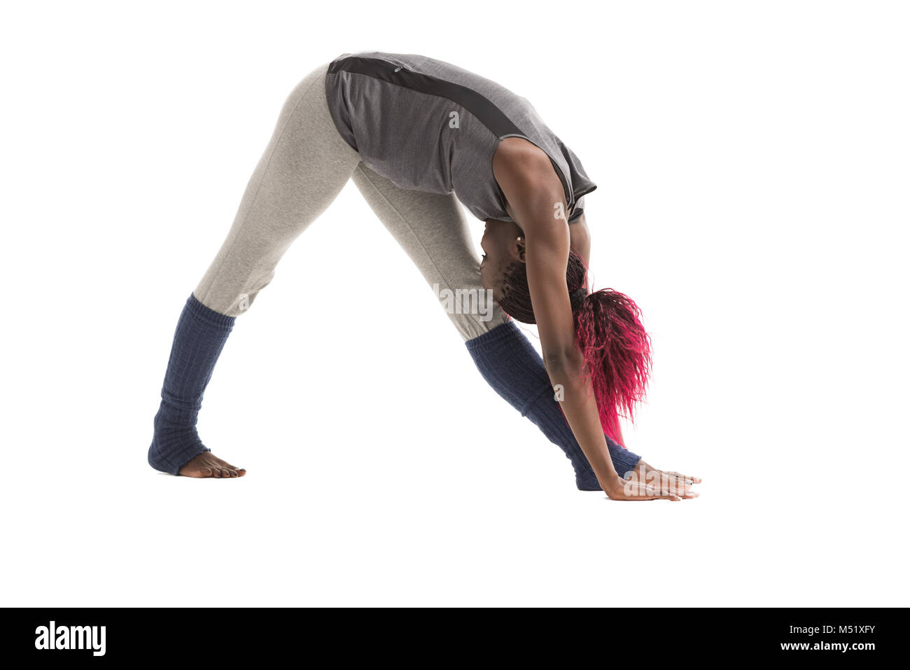 Young african woman doing yoga exercises isolated on white background ...