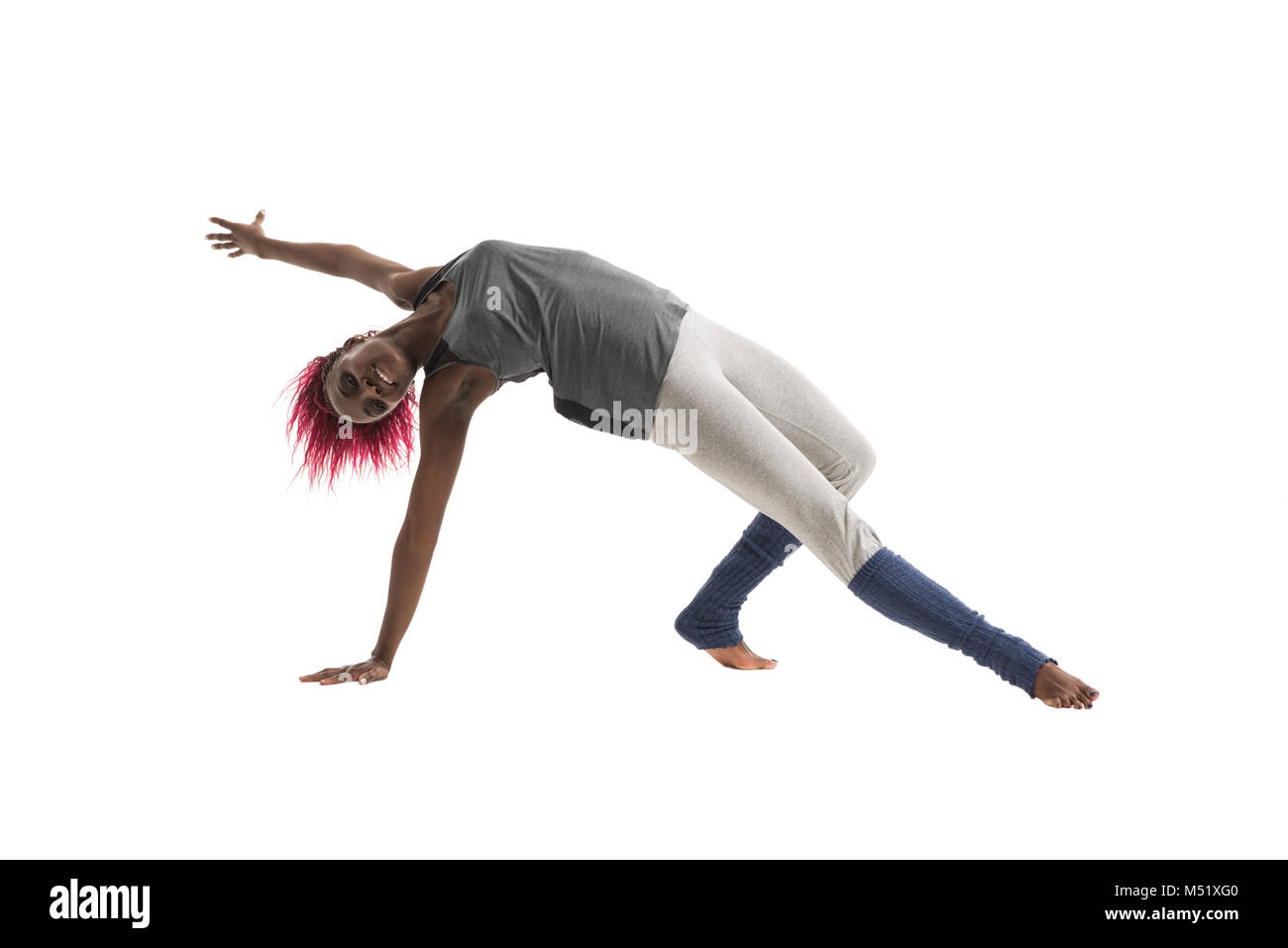 Young african woman doing yoga exercises isolated on white background ...