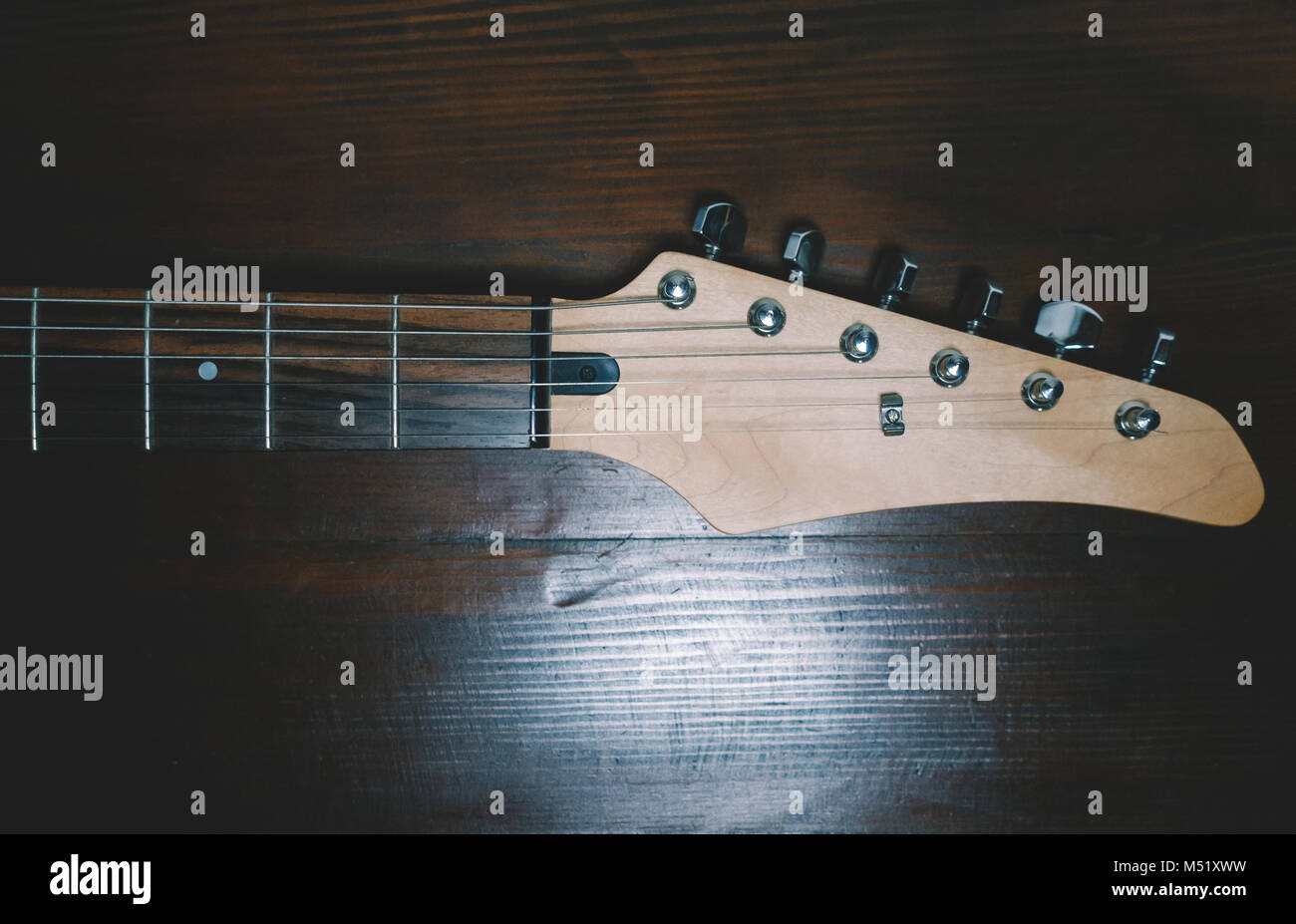 Guitar neck on dark wooden background Stock Photo - Alamy