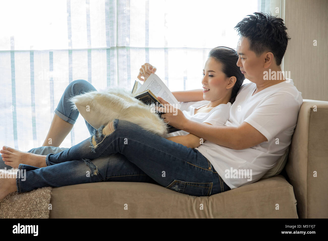 Young Couples reading book Stock Photo - Alamy