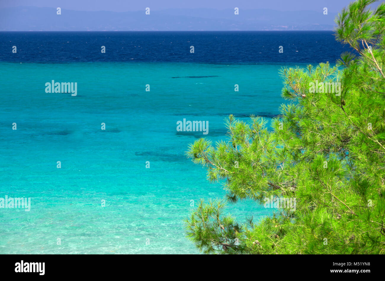 Blue sea shore under clear sky Stock Photo - Alamy