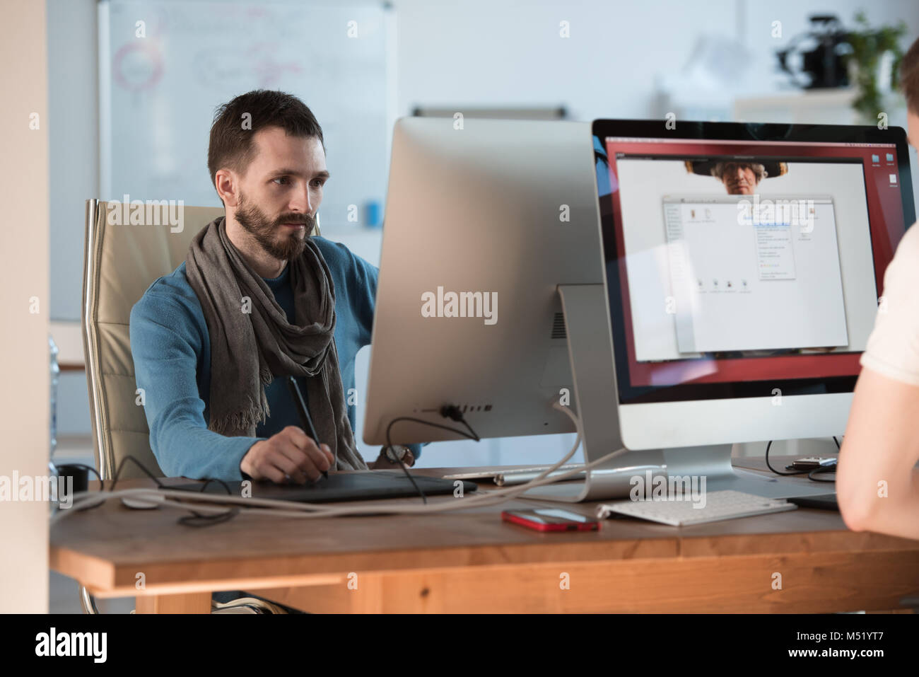 Artist or designer drawing something on graphic tablet at the office ...