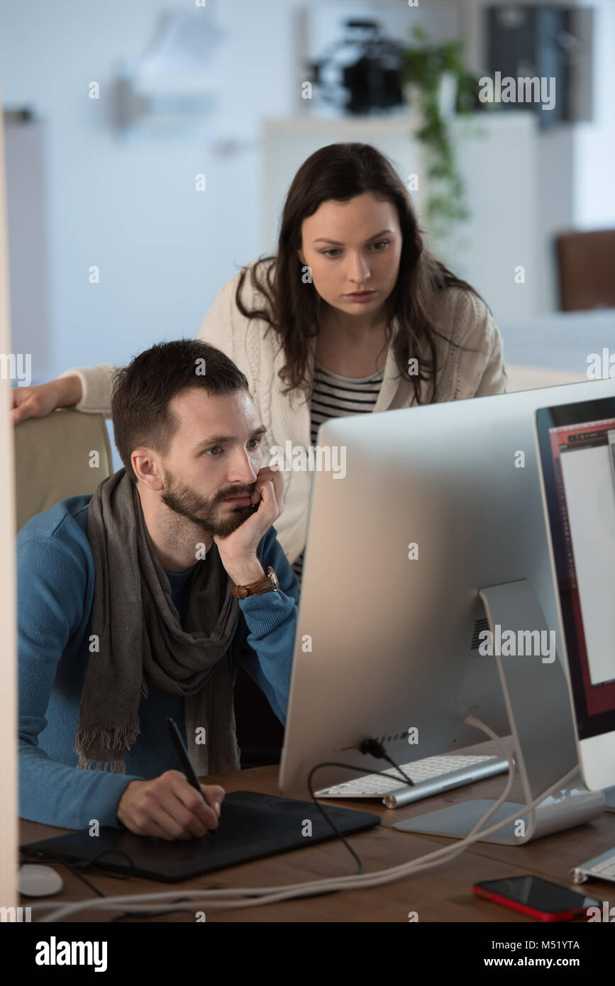 Artist or designer drawing something on graphic tablet at the office ...