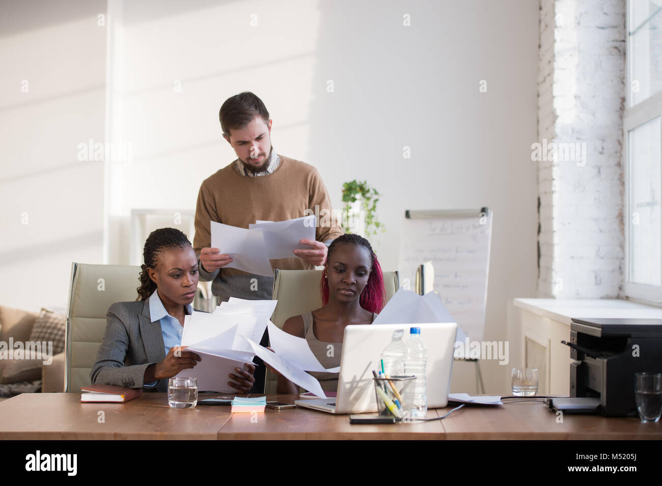 Image of group of three young business people of different ethnicity ...