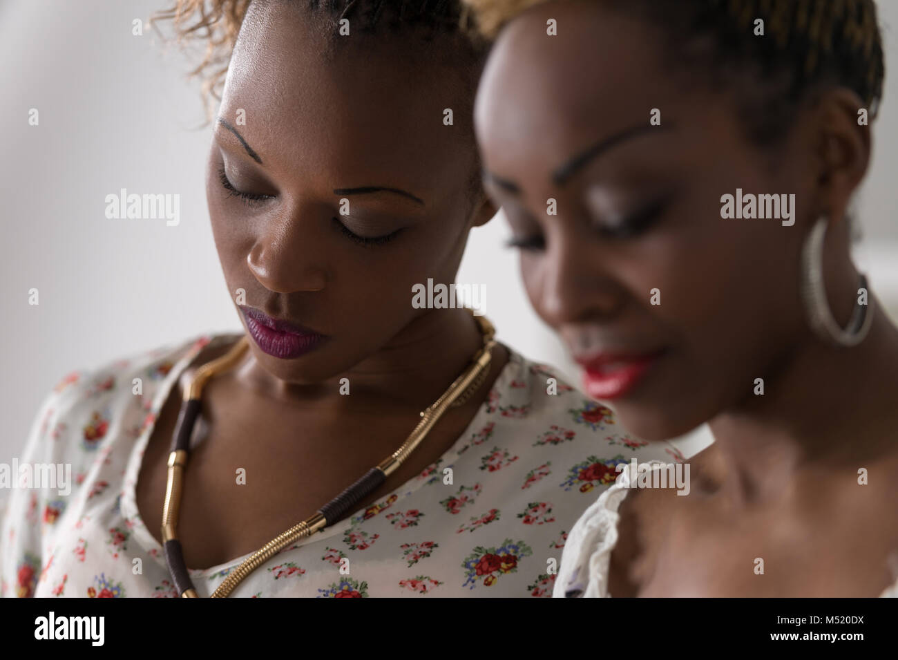 Closeup of two young african cheerful women friends together Stock ...