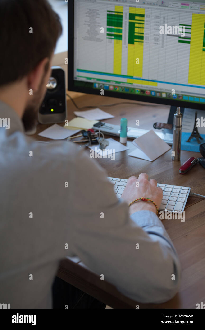 Handsome businessman working with computer in office. Photo from behind ...