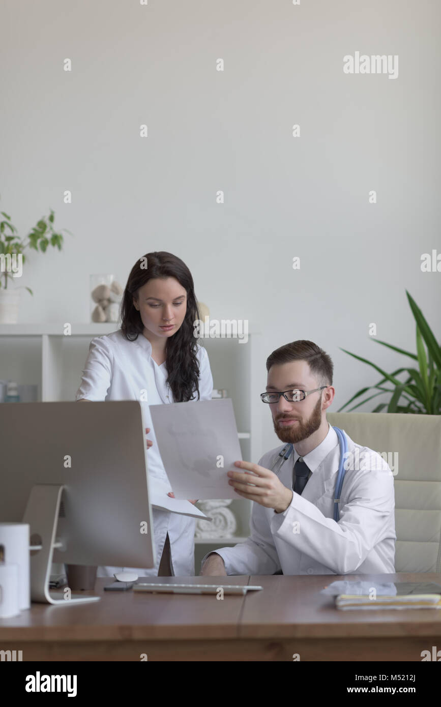Two doctors discussing test results and working together Stock Photo ...