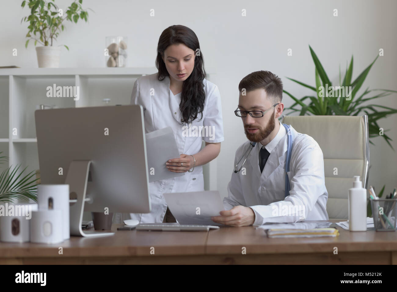 Two doctors discussing test results and working together Stock Photo ...