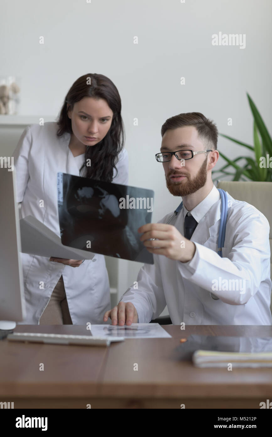 Doctors discussing intestines xray at medical office Stock Photo - Alamy