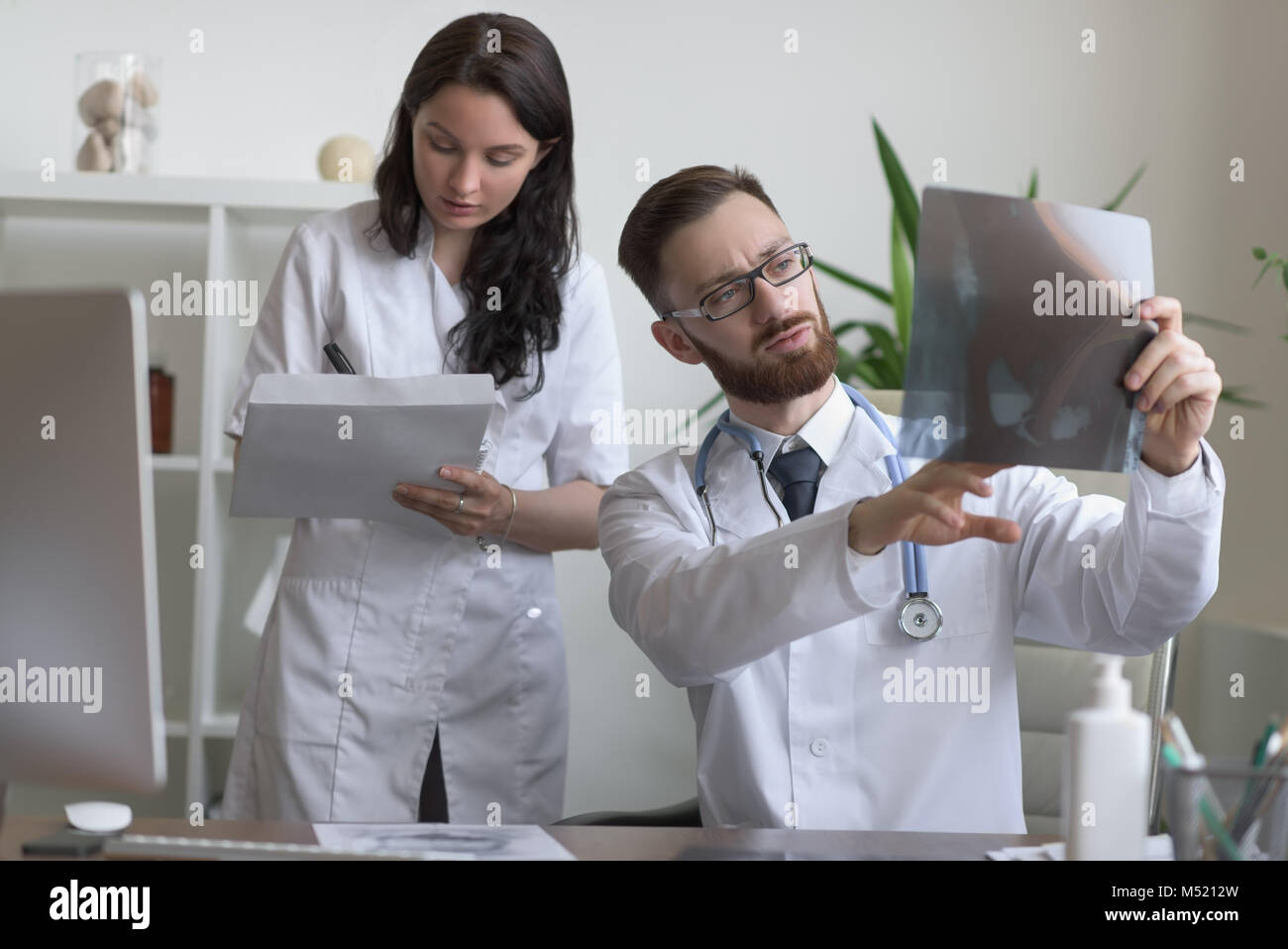 Doctors discussing intestines xray at medical office Stock Photo - Alamy