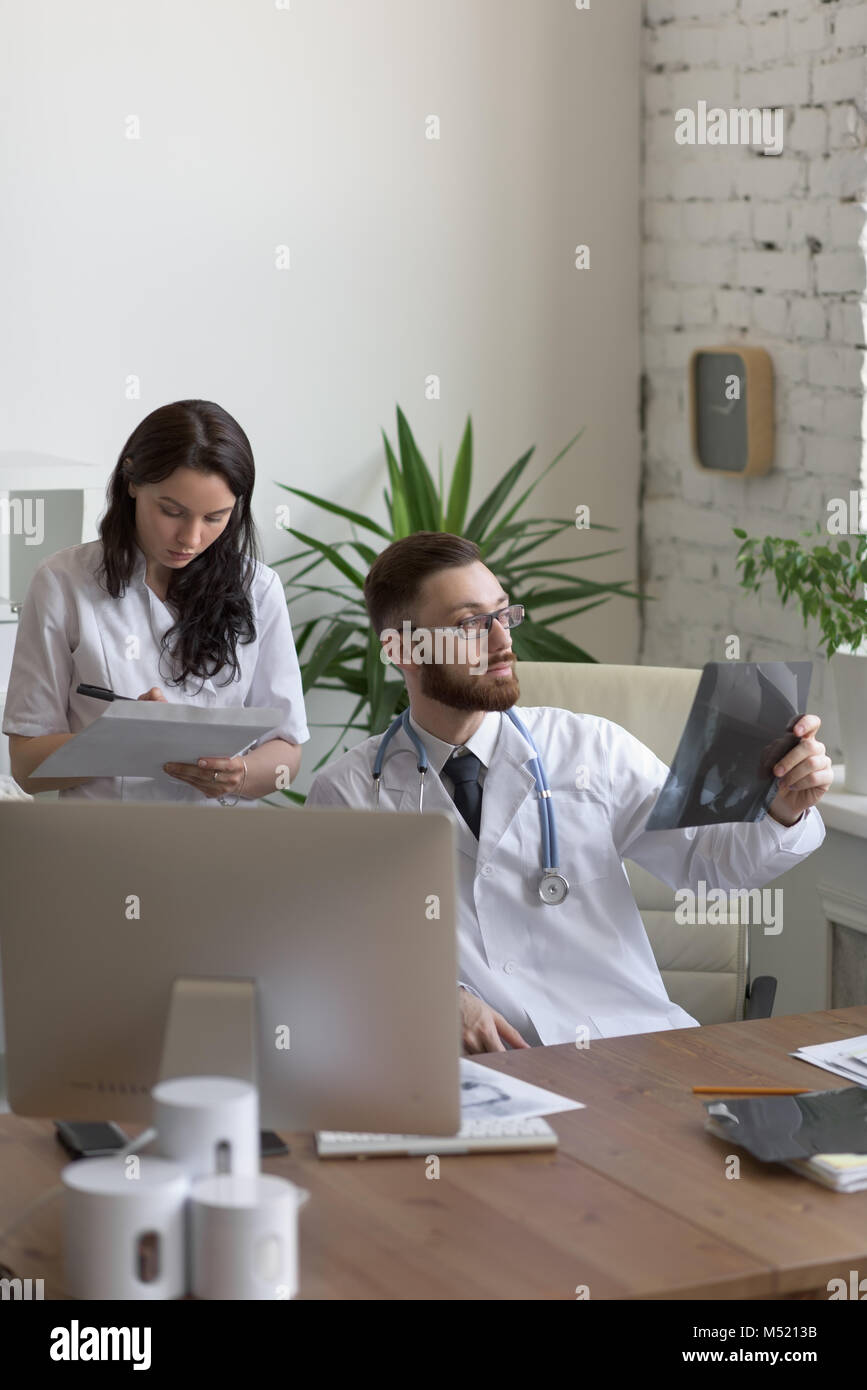 Doctors discussing intestines xray at medical office Stock Photo - Alamy