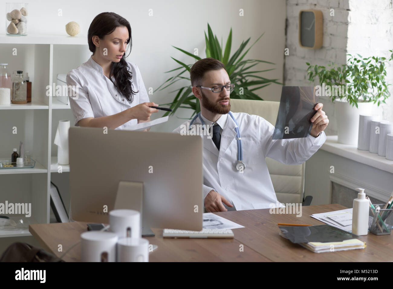 Doctors discussing intestines xray at medical office Stock Photo - Alamy