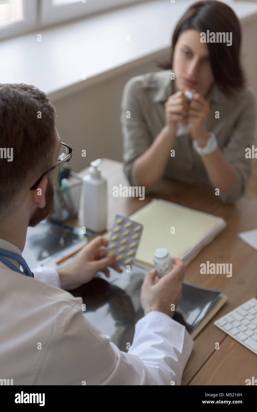 At doctor office. Doctor prescribing medication to patient Stock Photo ...