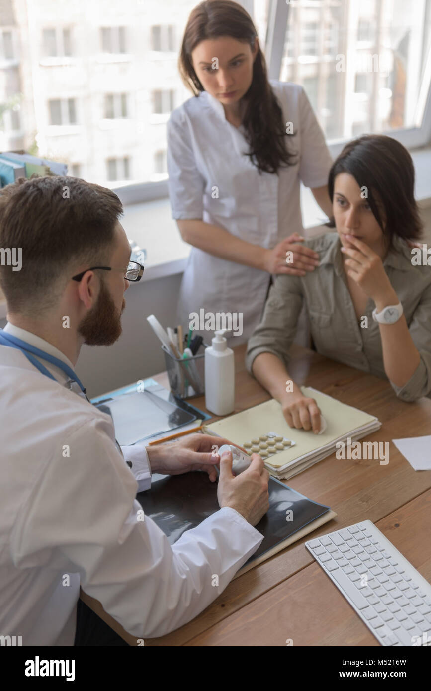 At doctor office. Doctor prescribing medication to patient Stock Photo ...
