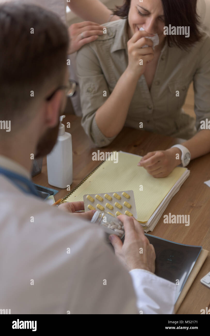 At doctor office. Doctor talking to crying patient after tests. Closeup ...