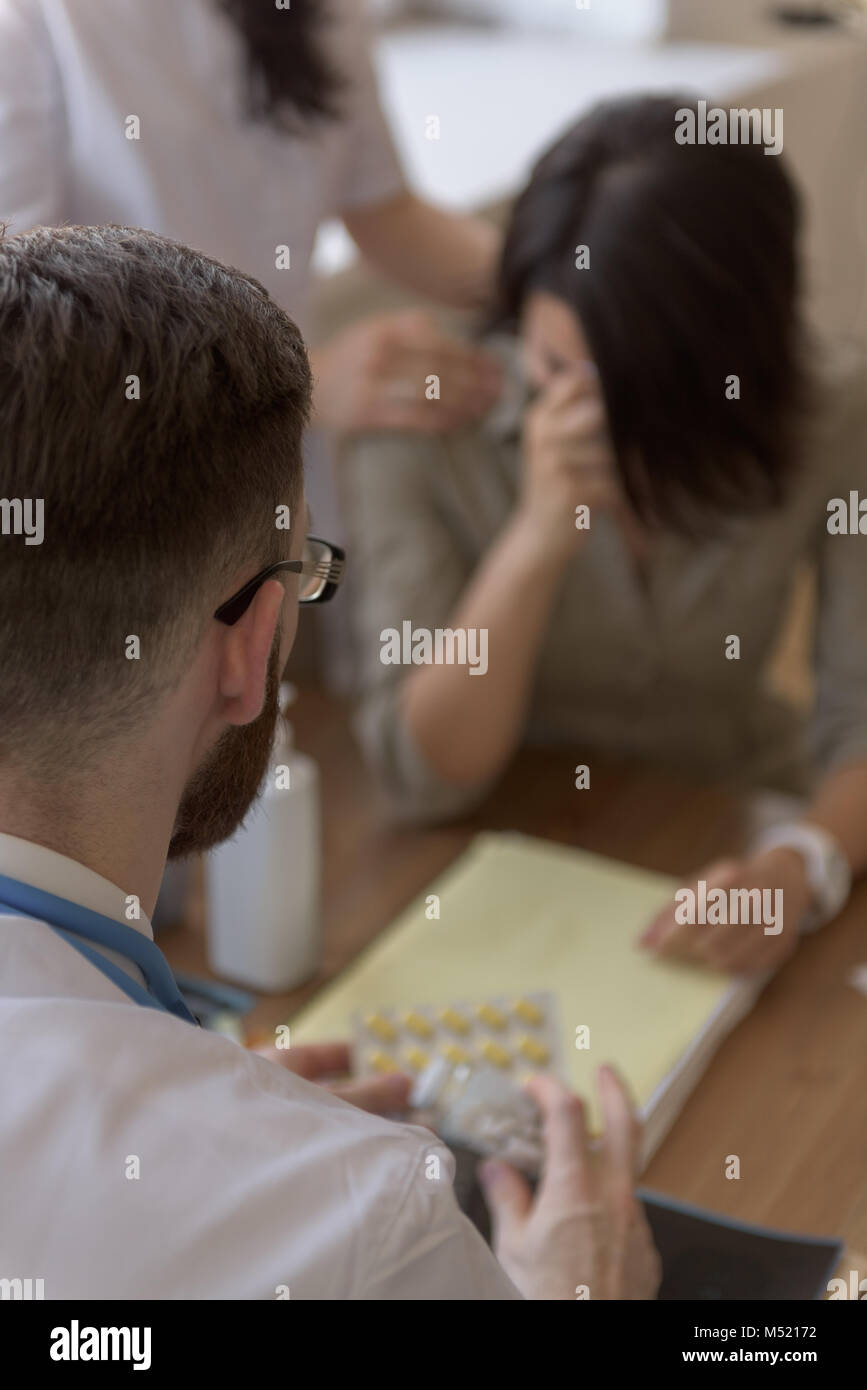 At doctor office. Doctor talking to crying patient after tests. Closeup ...