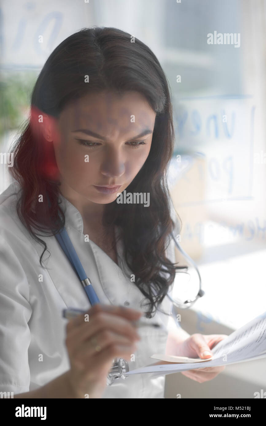 Doctor working at office with patient symptoms and test results Stock ...