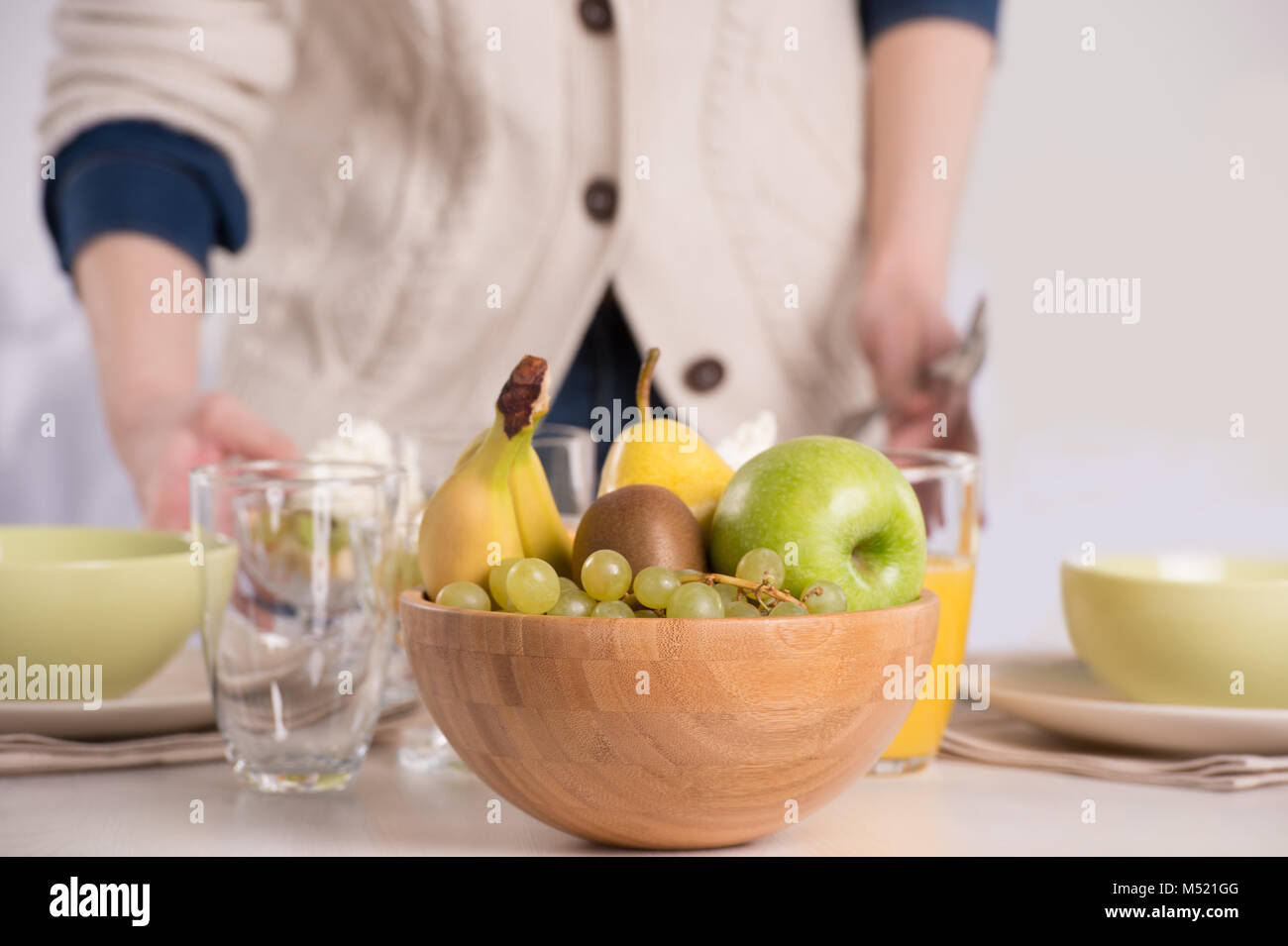 Human hands preparing table for lunch Stock Photo - Alamy