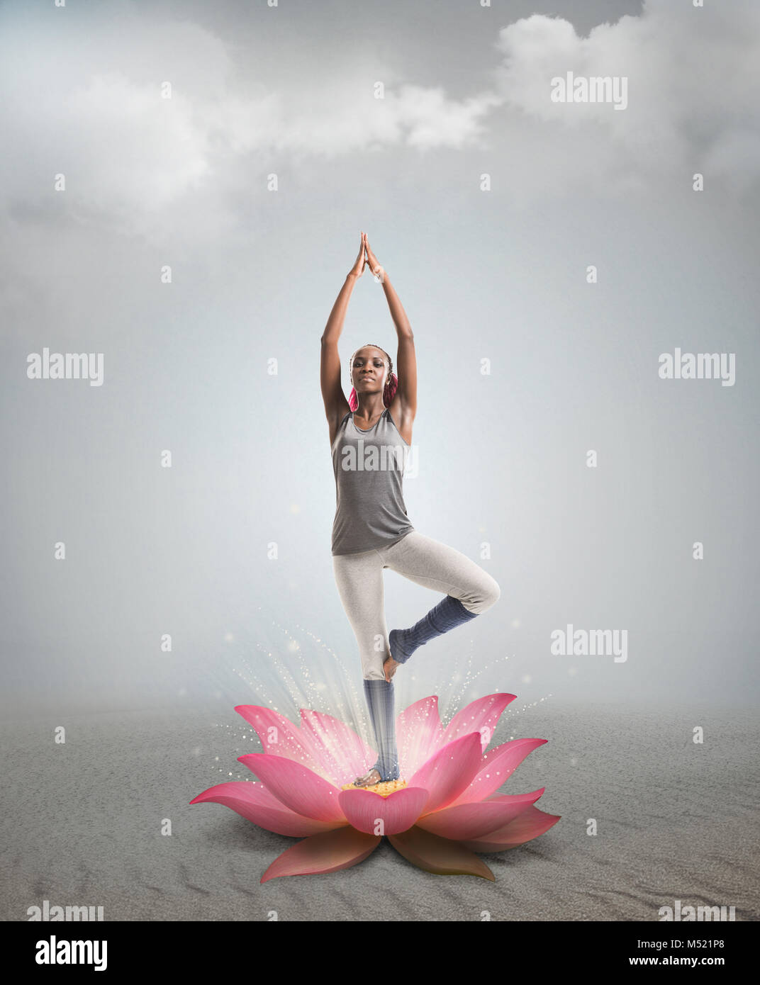 Young African woman in the stretching position in lotus flower Stock ...