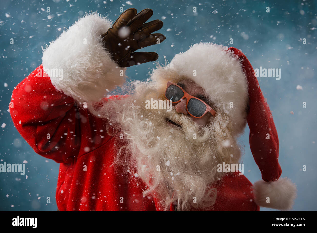 Santa Claus wearing sunglasses dancing outdoors at North Pole in ...