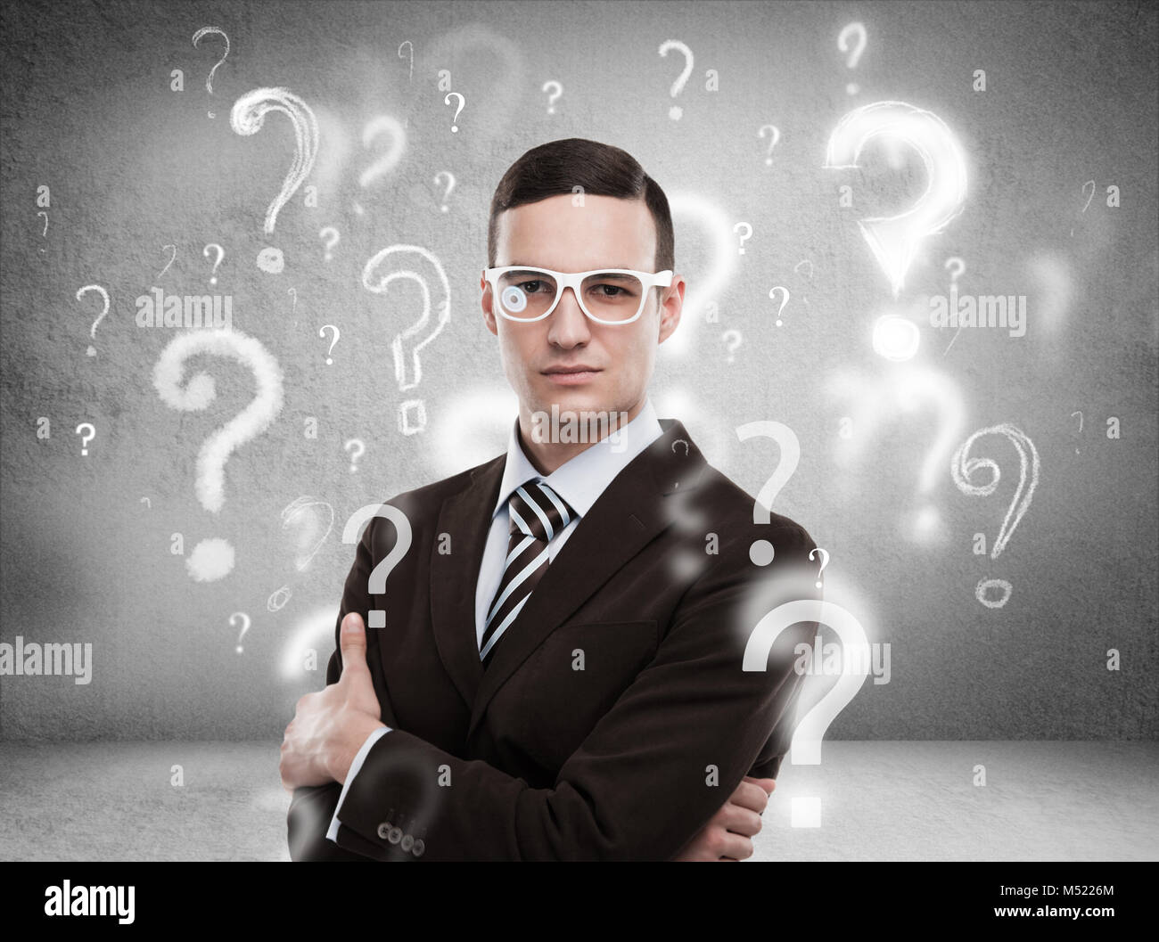 Handsome business man with question marks above his head Stock Photo ...