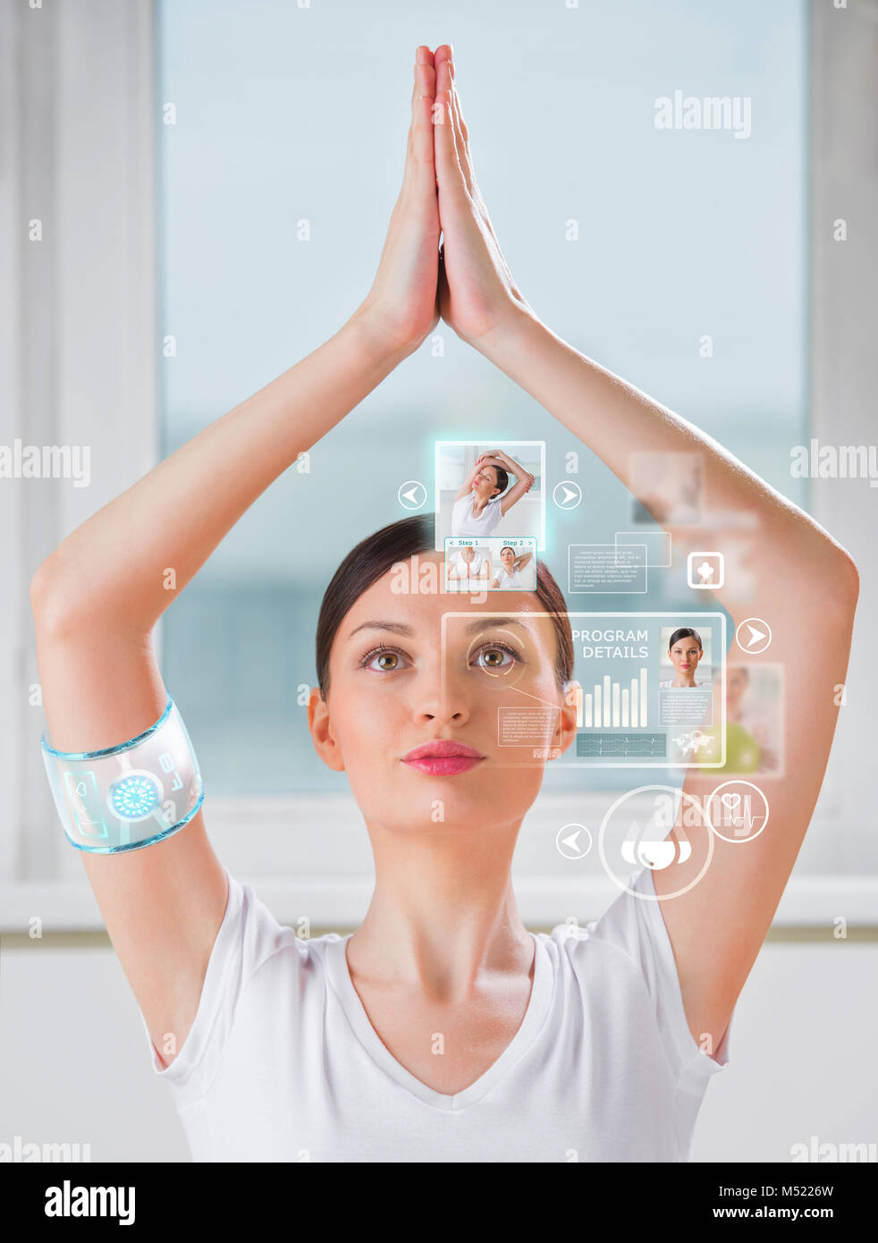 Woman doing exercise wearing smart wearable device with futuristic ...