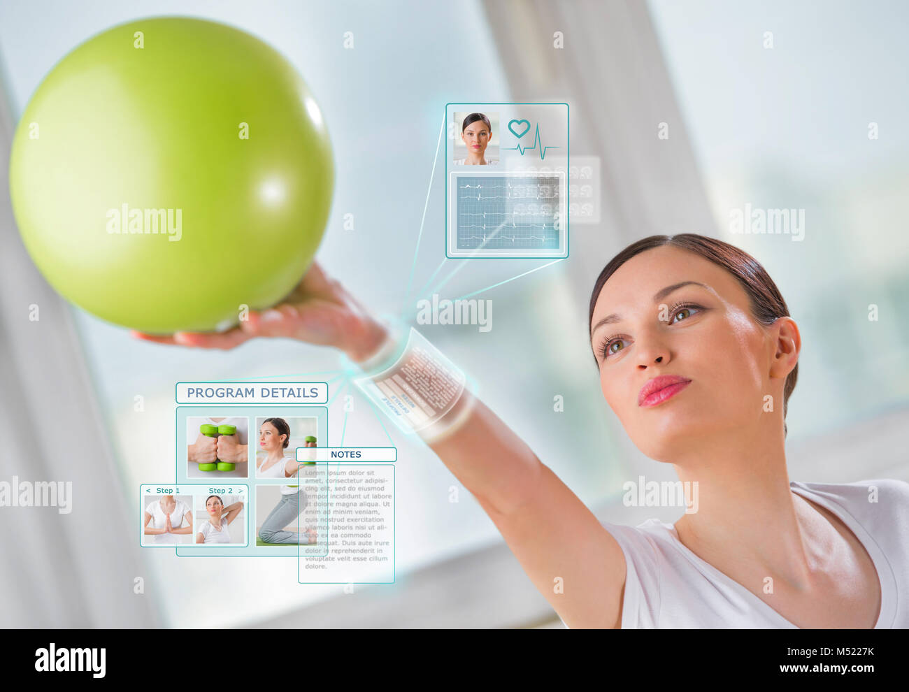 Woman doing exercise with ball wearing smart wearable device with ...